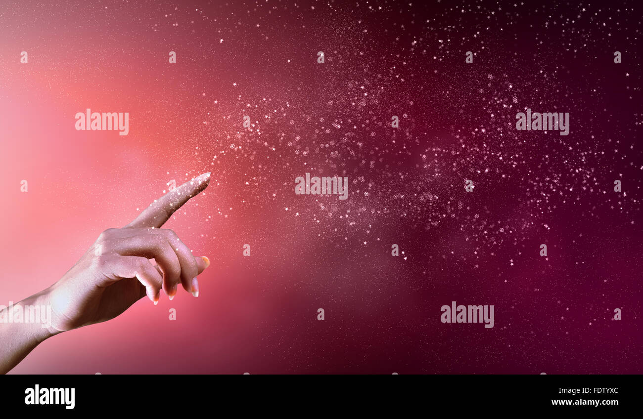 magical hand conceptual image with sparkles on colour background Stock Photo - Alamy