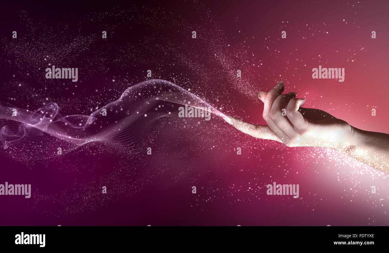 magical hand conceptual image with sparkles on colour background Stock ...