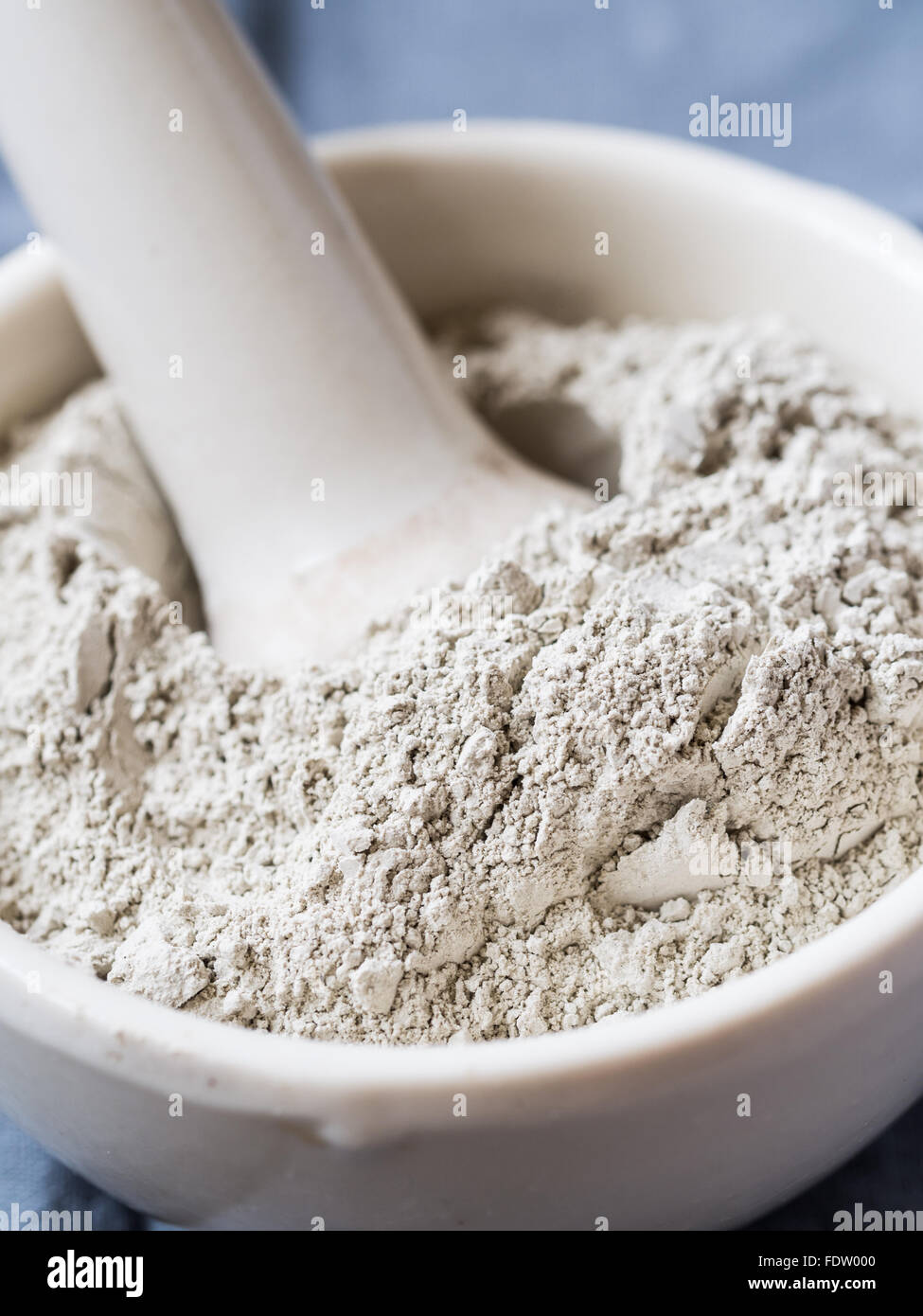 Cosmetic green clay powder in mortar Stock Photo - Alamy