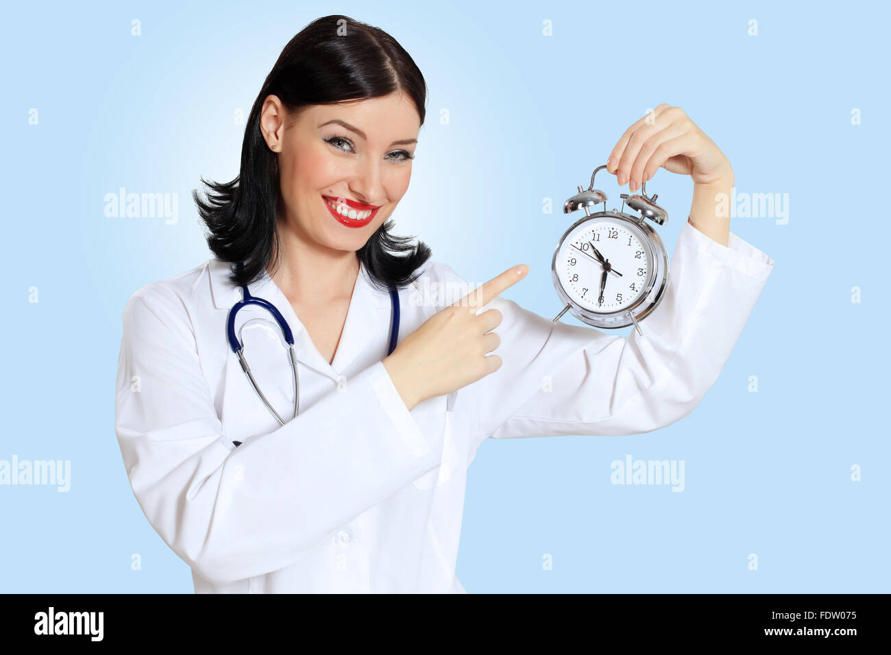 Portrait of happy successful young female doctor holding clocks Stock ...