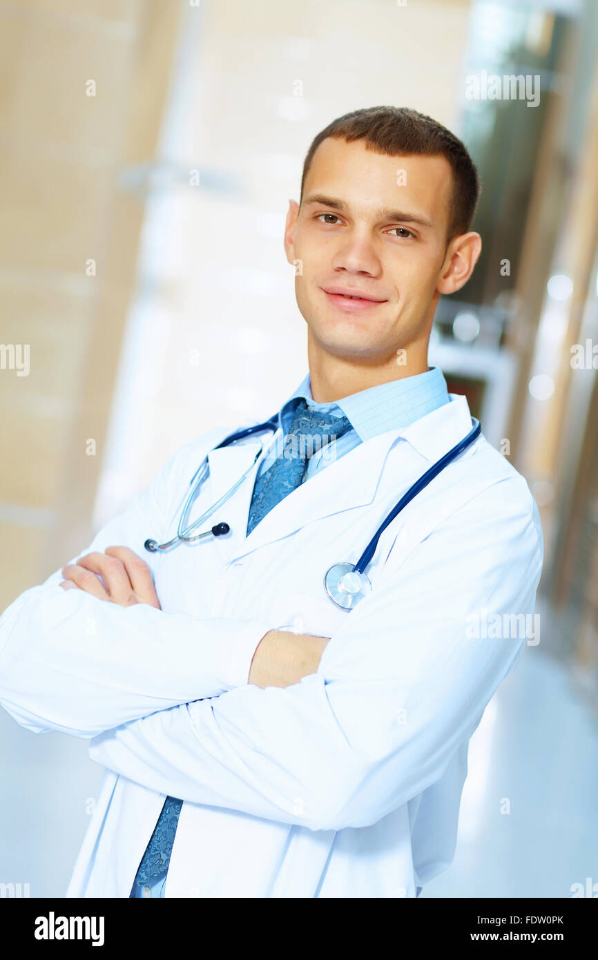Portrait of friendly male doctor in hospital smiling Stock Photo - Alamy