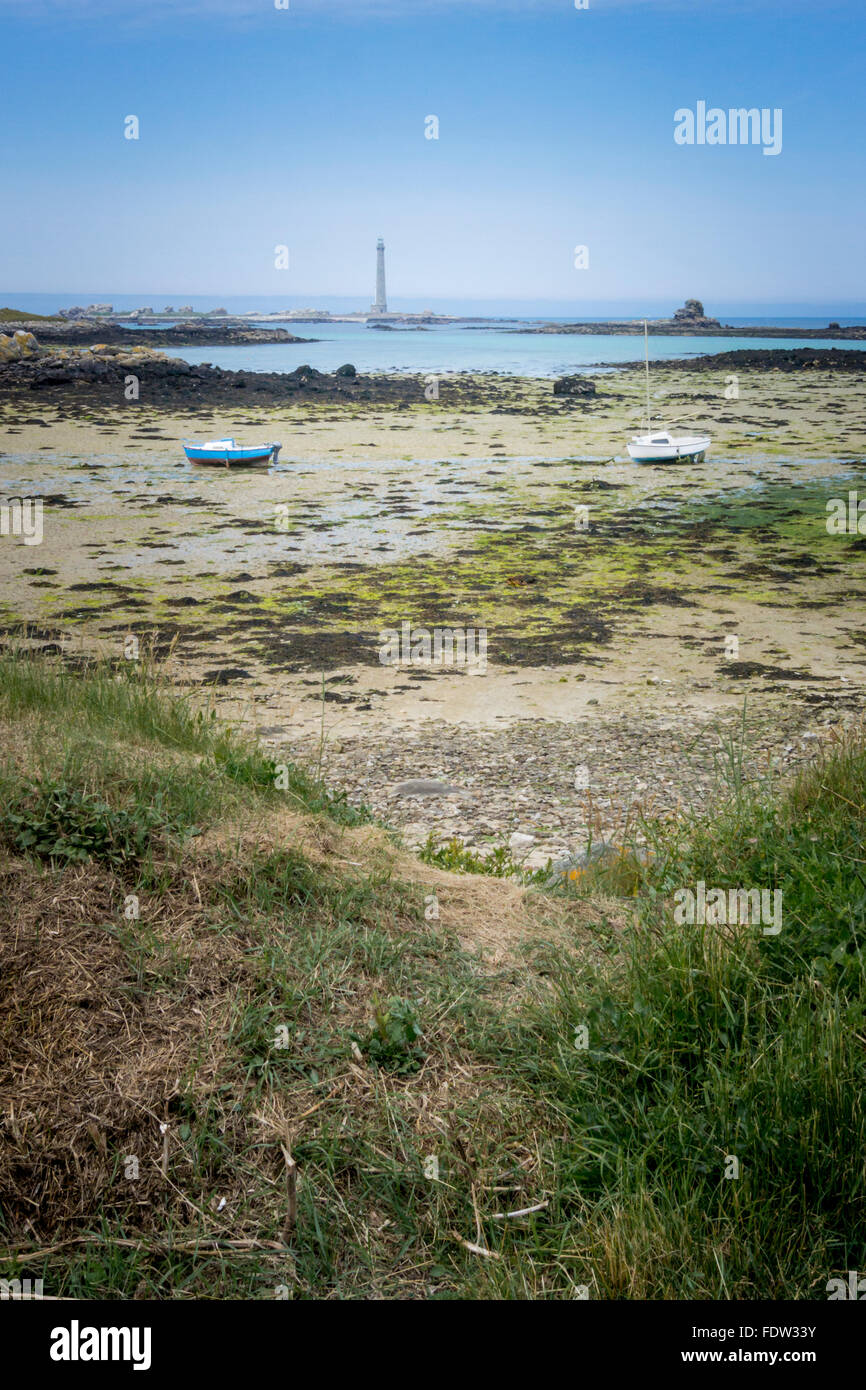 Boats stranded on the beach at low tide in Brittany, France, with a ...