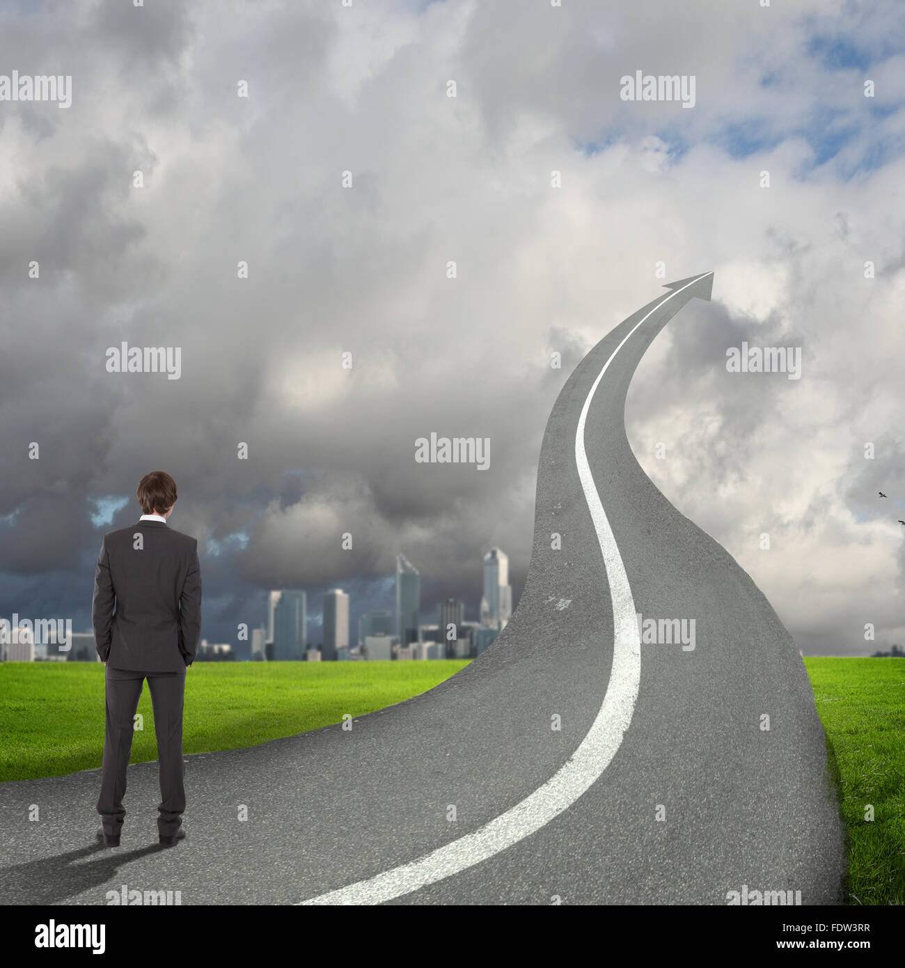 Concept of the road to success with a businessman standing on the road ...