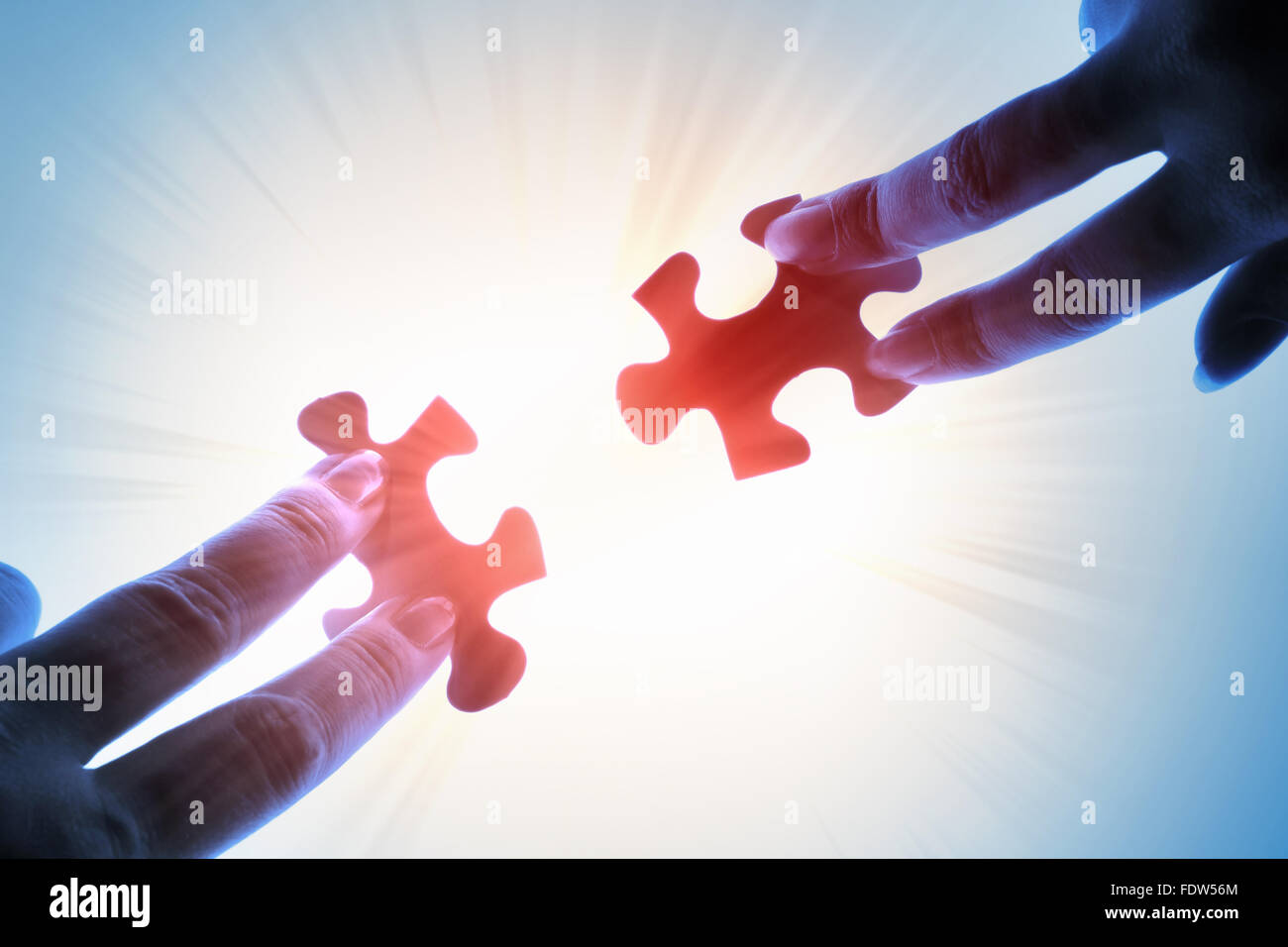 puzzle piece coming down into its place Stock Photo - Alamy