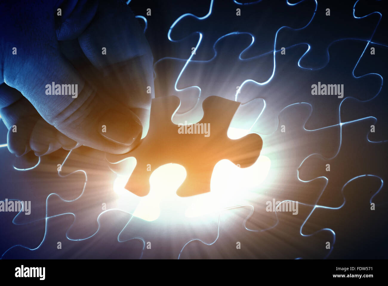 puzzle piece coming down into its place Stock Photo - Alamy