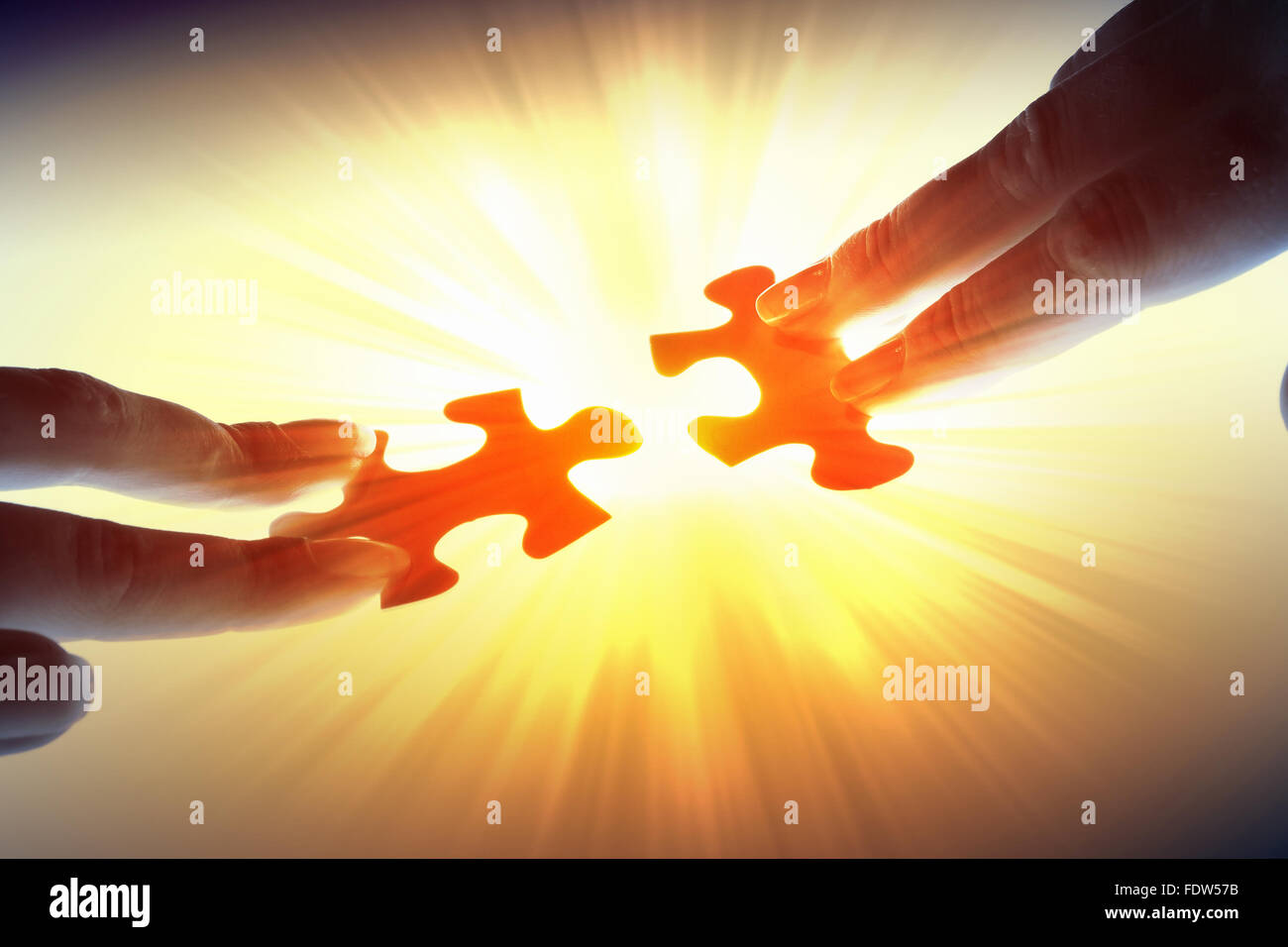 puzzle piece coming down into its place Stock Photo - Alamy