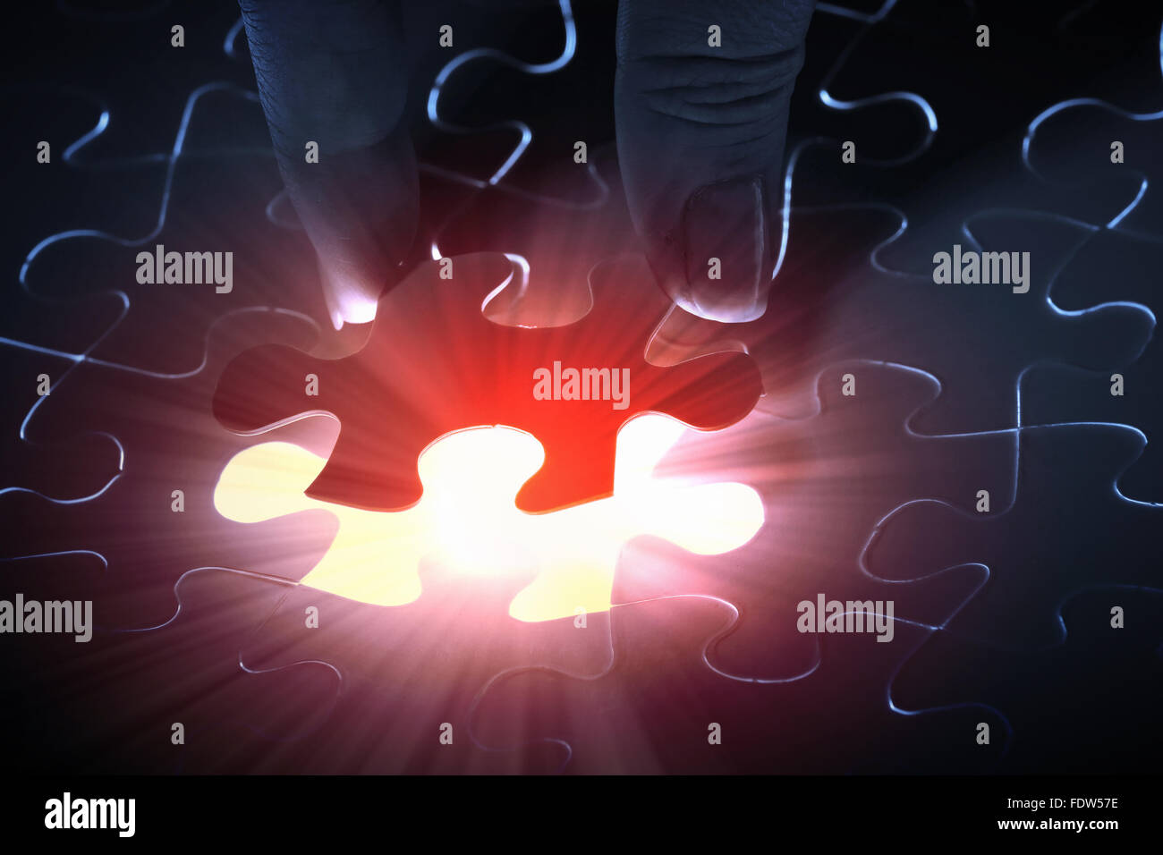 puzzle piece coming down into its place Stock Photo - Alamy
