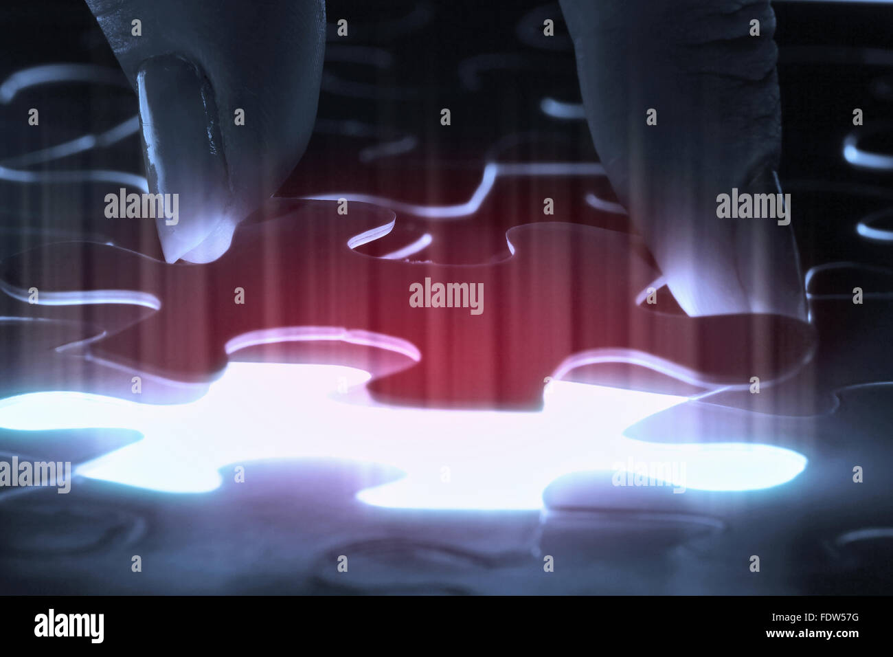 puzzle piece coming down into its place Stock Photo - Alamy