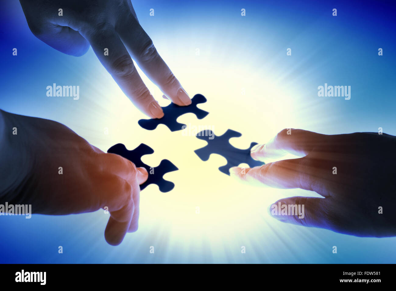 puzzle piece coming down into its place Stock Photo - Alamy