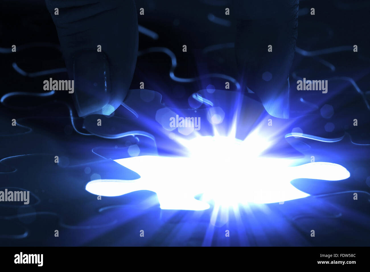 puzzle piece coming down into its place Stock Photo - Alamy