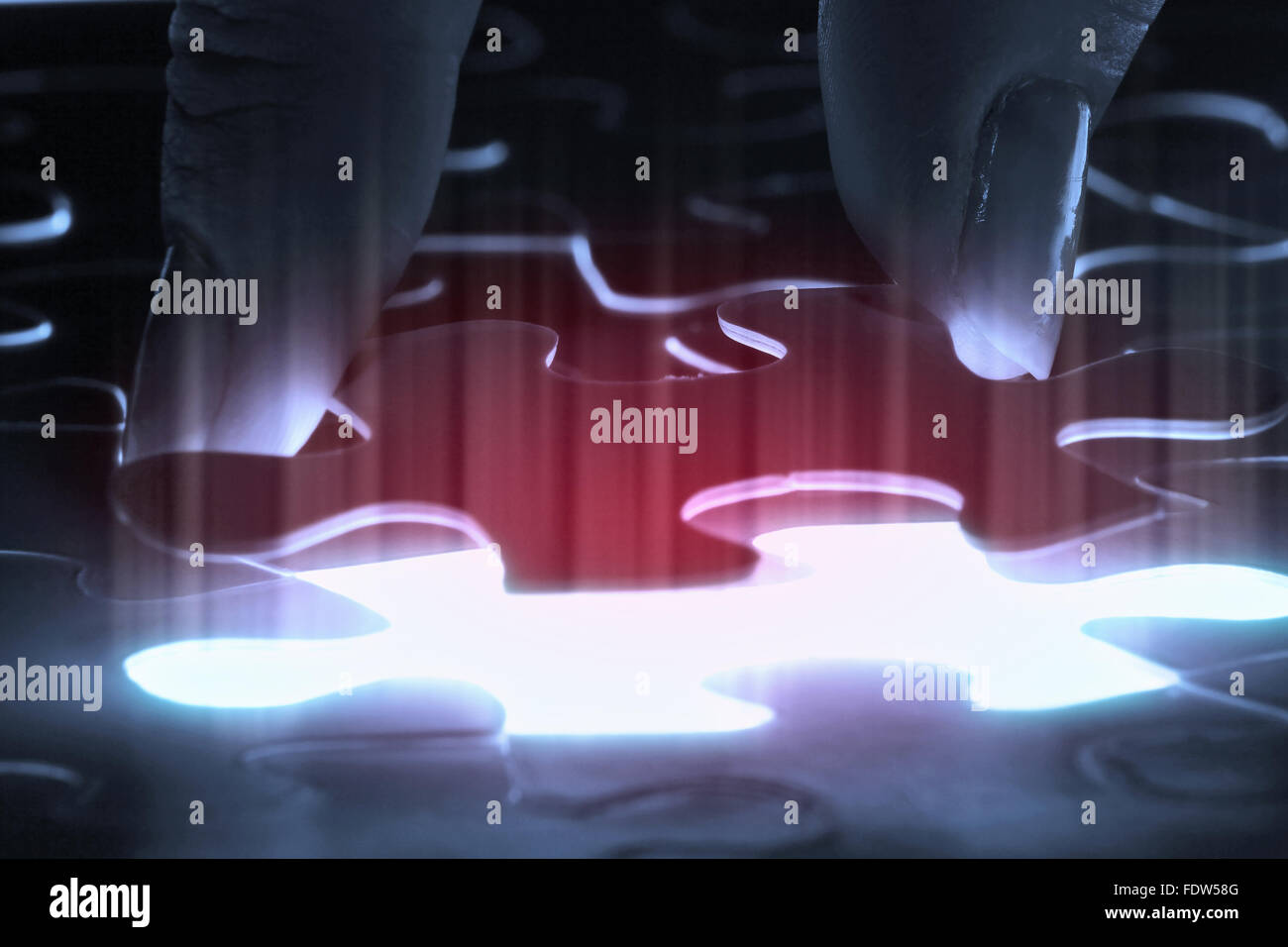puzzle piece coming down into its place Stock Photo - Alamy