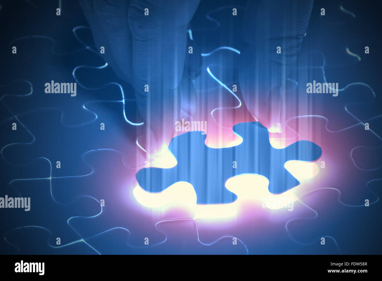 puzzle piece coming down into its place Stock Photo - Alamy