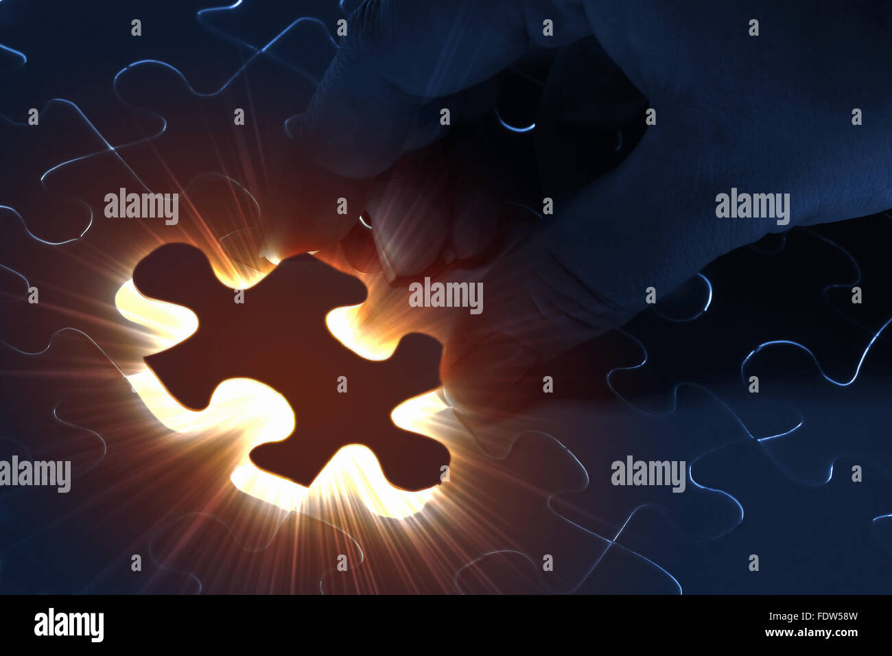 puzzle piece coming down into its place Stock Photo - Alamy