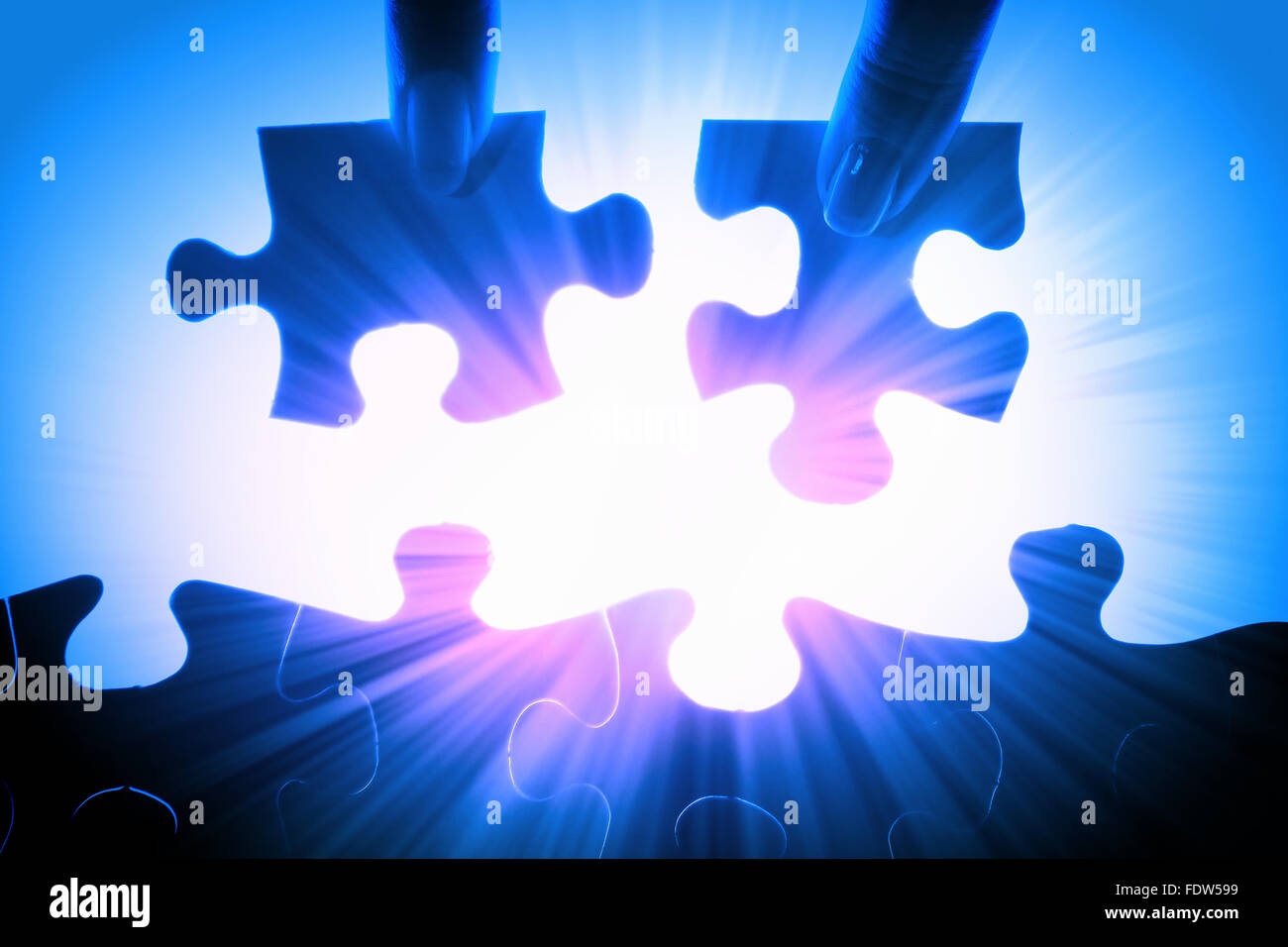 puzzle piece coming down into its place Stock Photo - Alamy