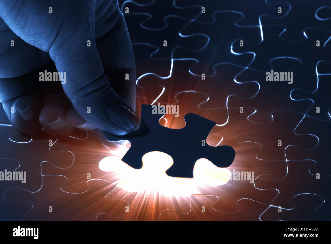 puzzle piece coming down into its place Stock Photo - Alamy