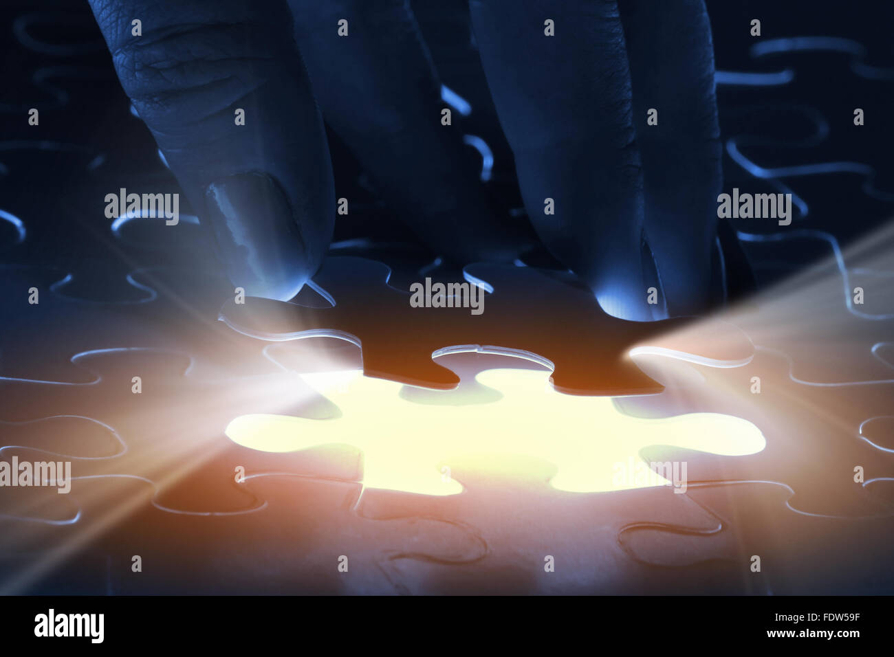 puzzle piece coming down into its place Stock Photo - Alamy