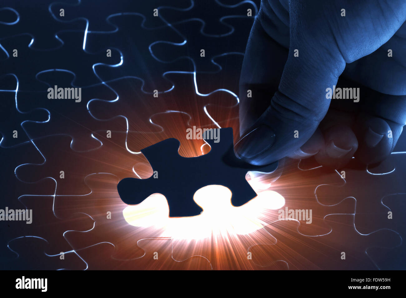 puzzle piece coming down into its place Stock Photo - Alamy