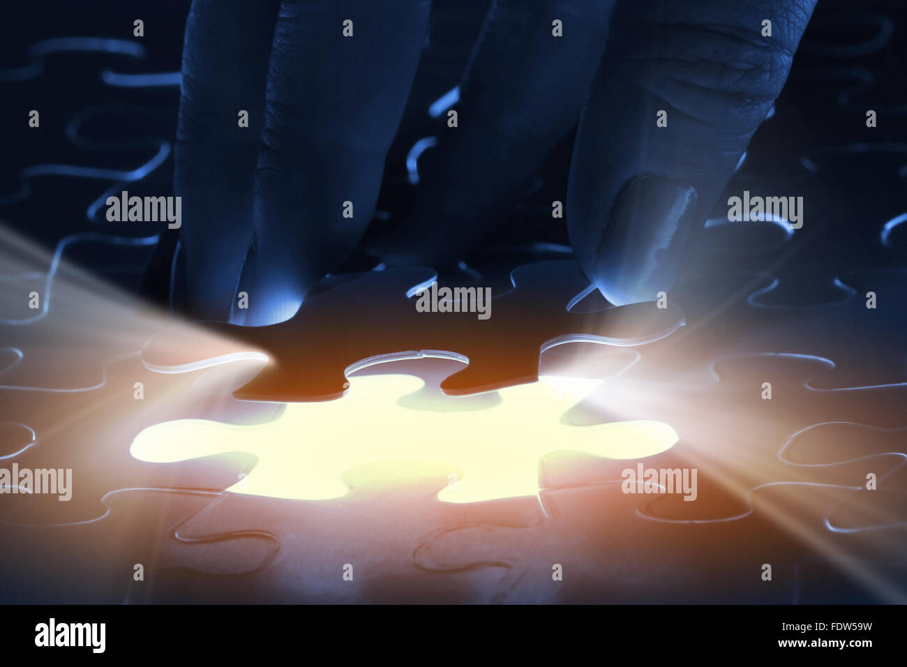 puzzle piece coming down into its place Stock Photo - Alamy