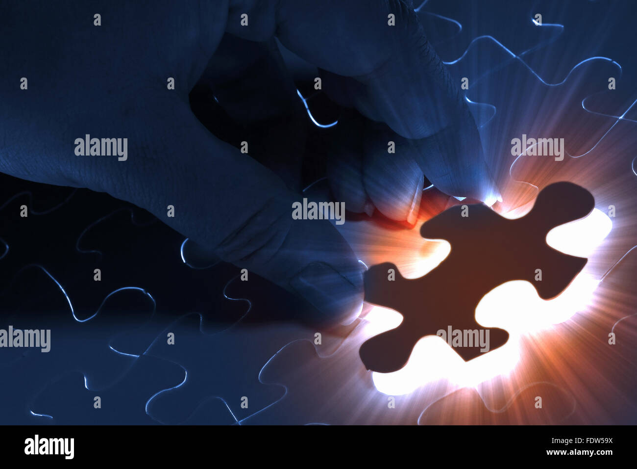 puzzle piece coming down into its place Stock Photo - Alamy