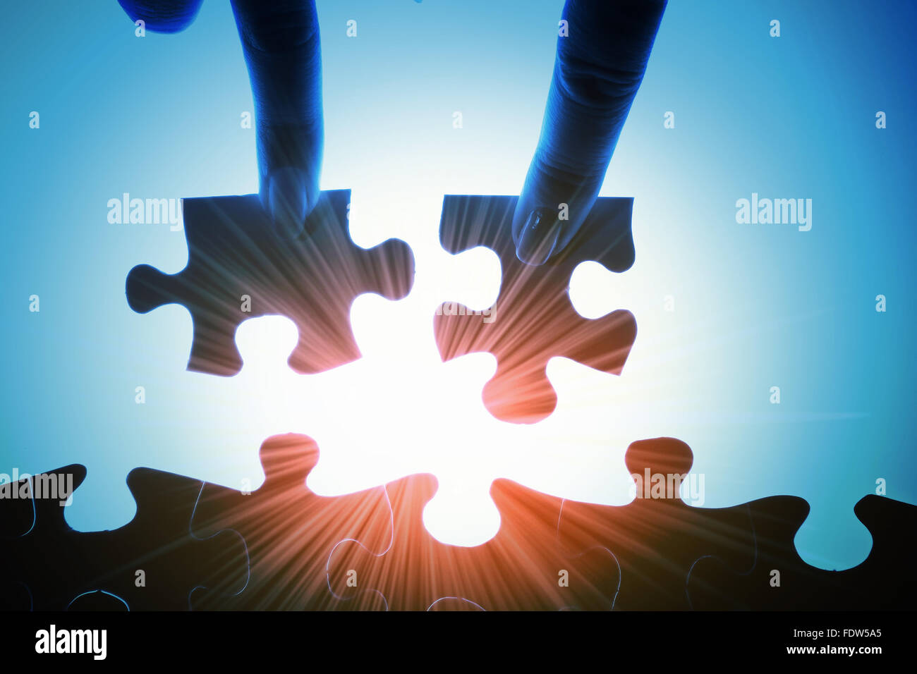 puzzle piece coming down into its place Stock Photo - Alamy