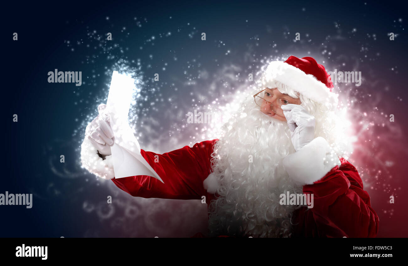 Santa holding Christmas letters and looking at camera Stock Photo - Alamy
