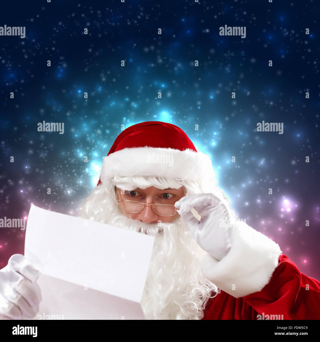 Santa holding Christmas letters and looking at camera Stock Photo - Alamy