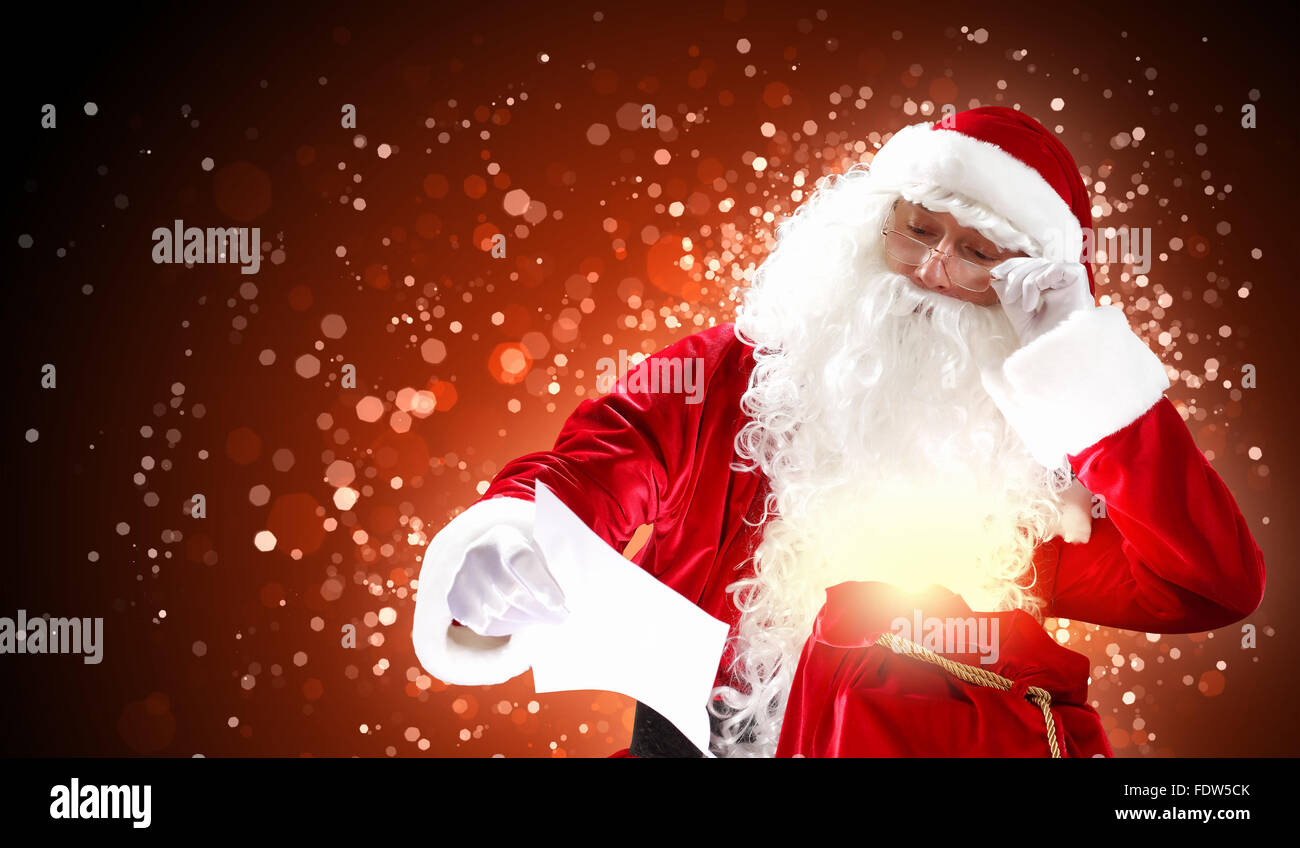 Santa holding Christmas letters and looking at camera Stock Photo - Alamy