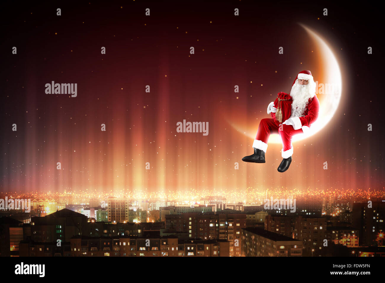 Santa Claus on the moon above a city at night Stock Photo - Alamy