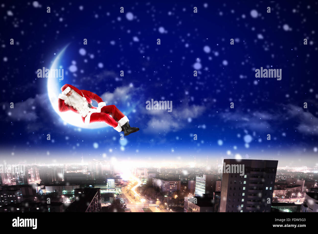 Santa Claus on the moon above a city at night Stock Photo - Alamy