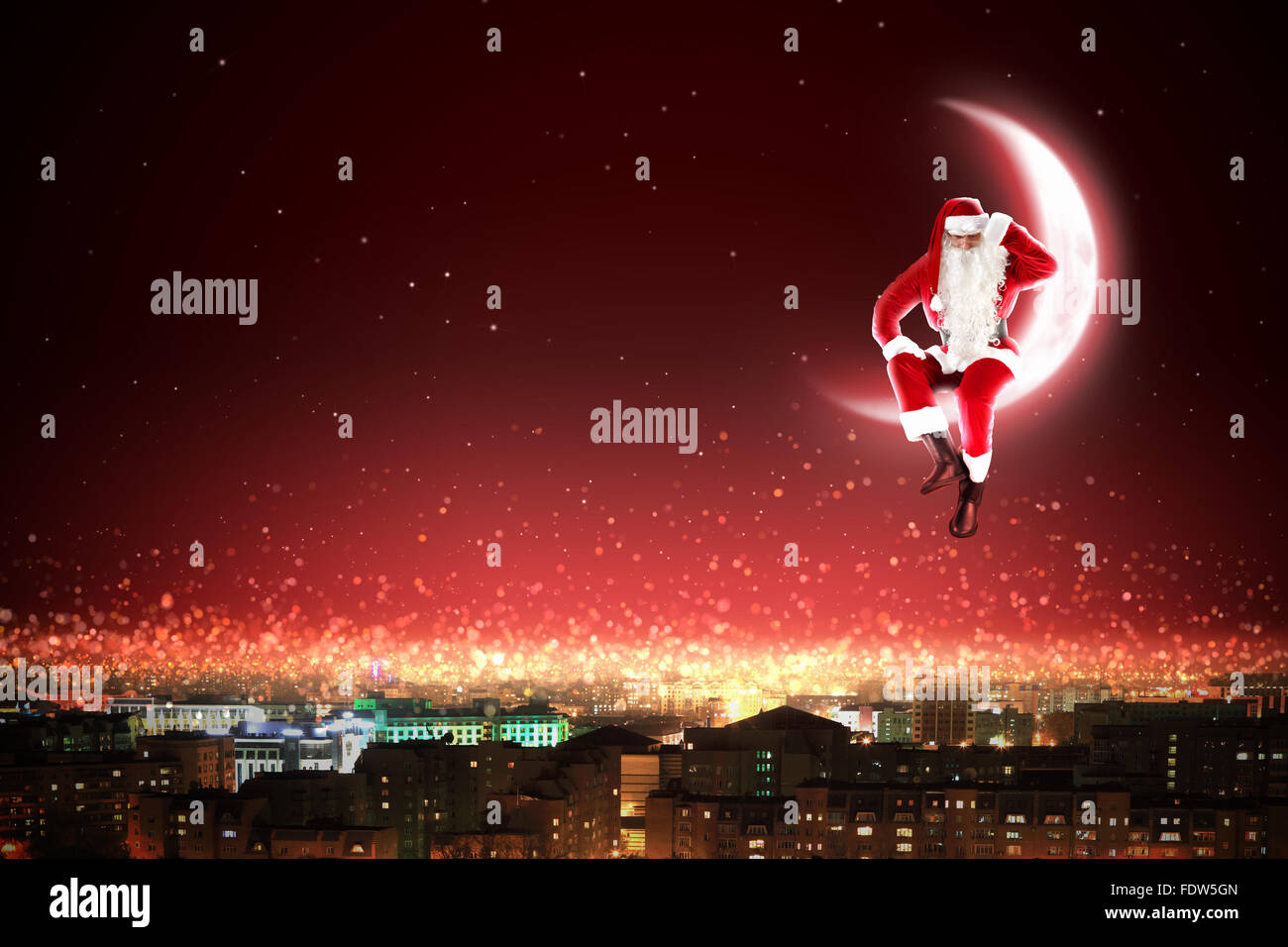 Santa Claus on the moon above a city at night Stock Photo - Alamy