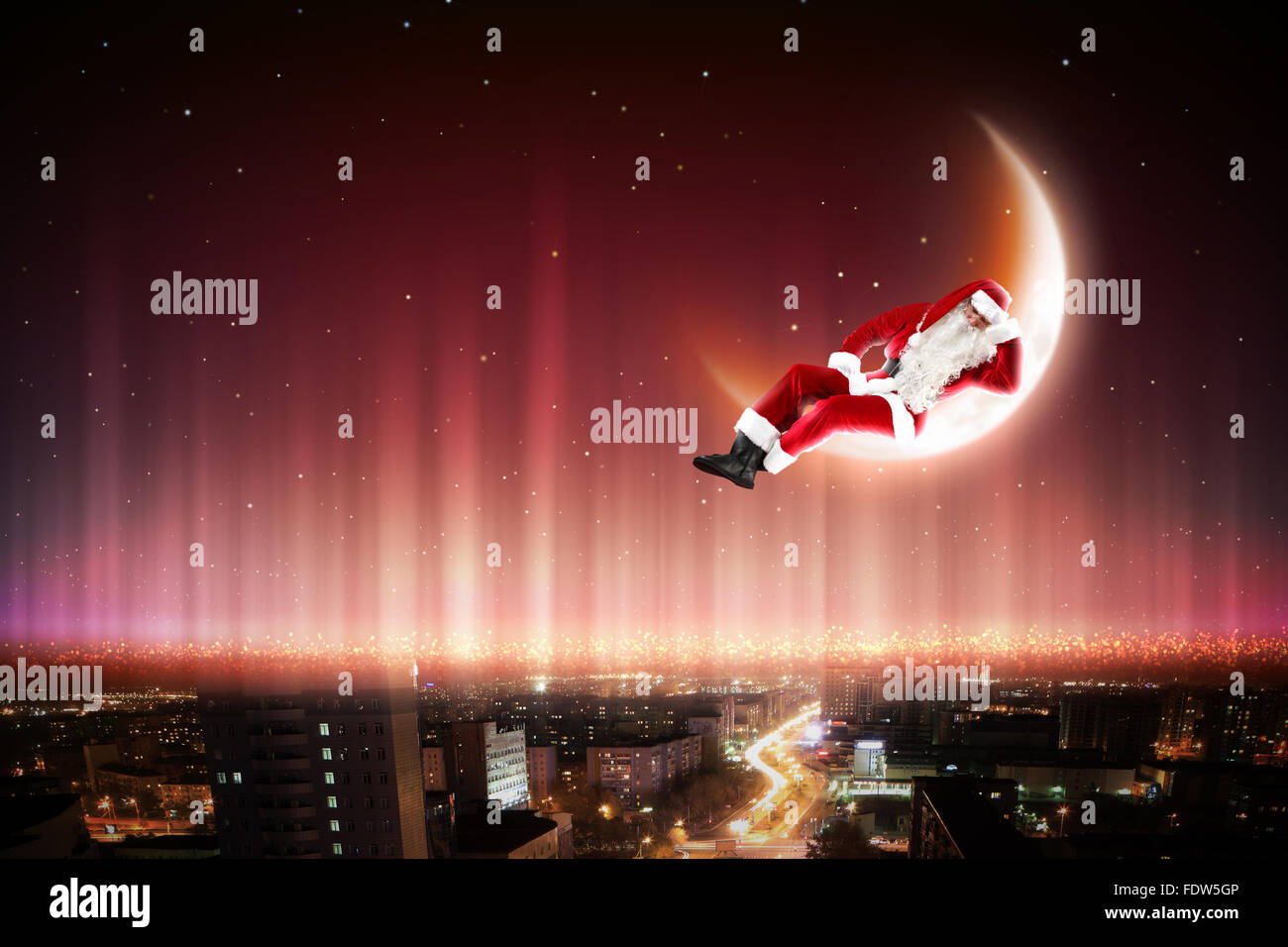 Santa Claus on the moon above a city at night Stock Photo - Alamy
