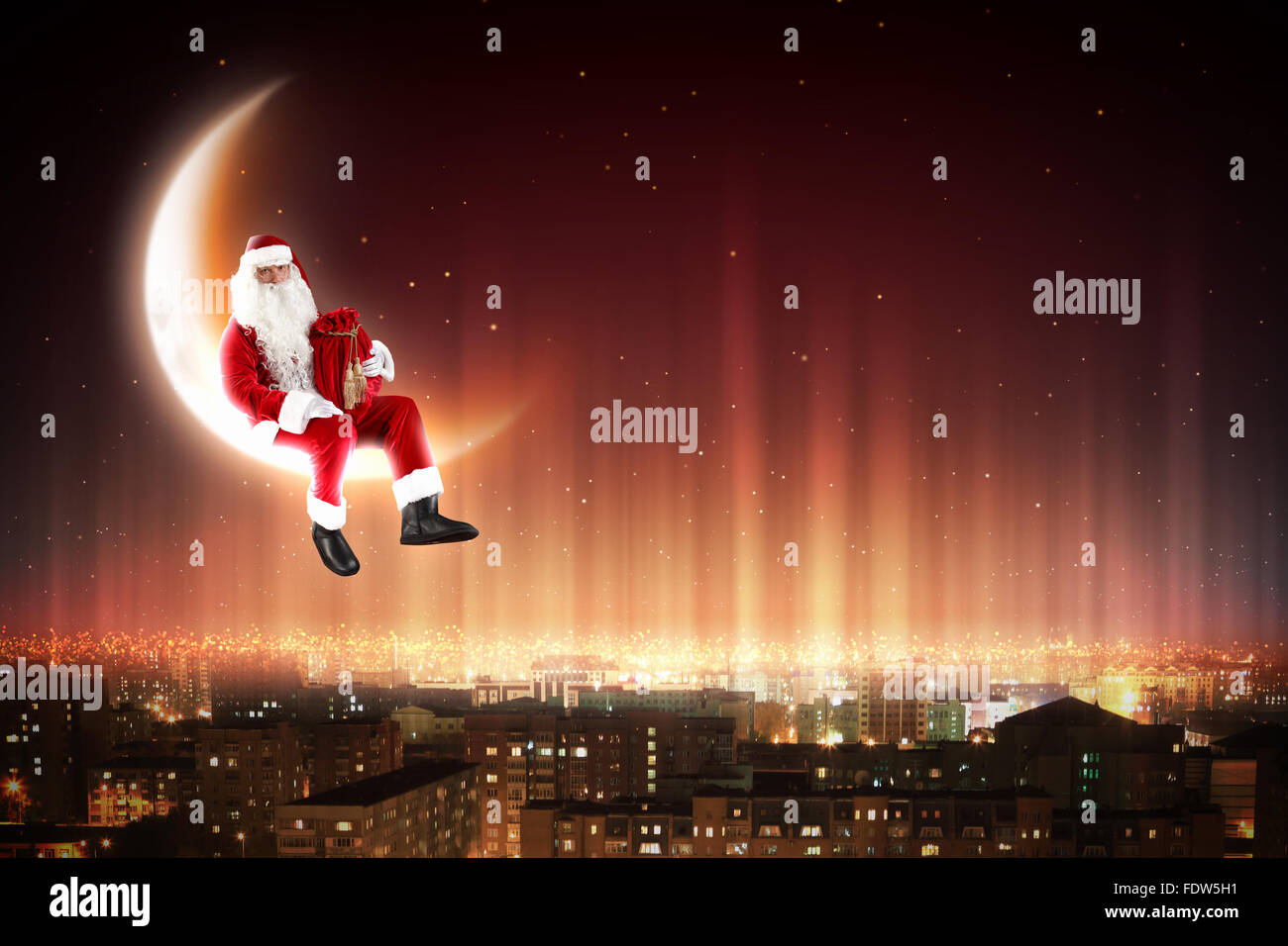 Santa Claus on the moon above a city at night Stock Photo - Alamy
