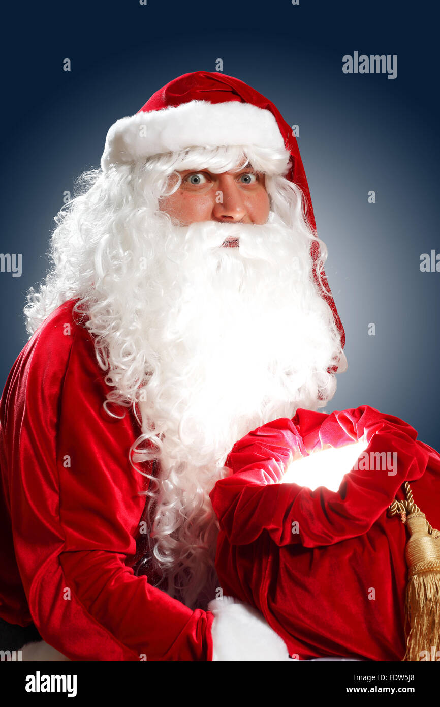 Santa Claus with his magic gift red bag full of presents Stock Photo ...