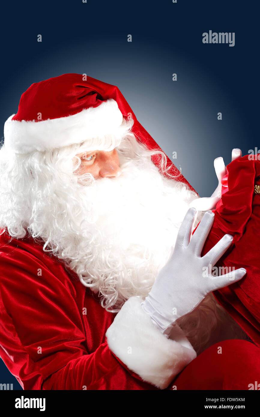 Santa Claus holding and reading a letter to him Stock Photo - Alamy