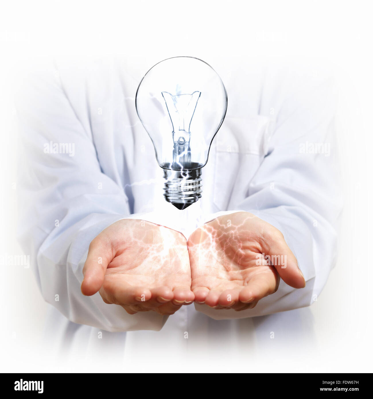 Hand with lamp and hands of a business person Stock Photo - Alamy