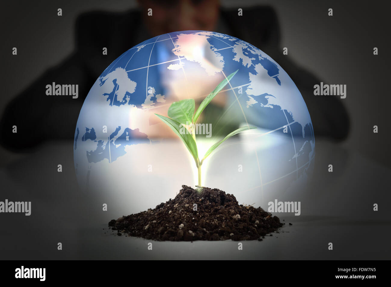 hands, the young sprout and our planet Earth Stock Photo - Alamy