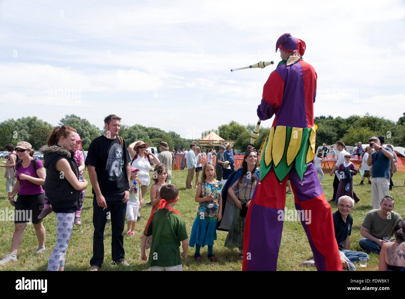 TEWKESBURY, GLOC. UK-11 JULY: Jester on stilts walks amongst crowd ...