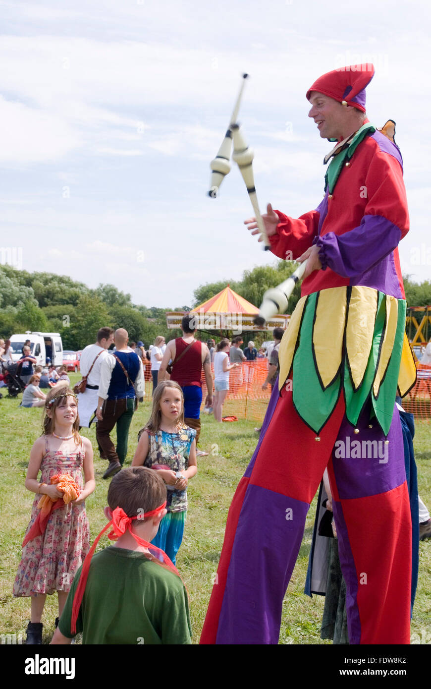 TEWKESBURY, GLOC. UK-11 JULY: Jester on stilts walks amongst crowd ...