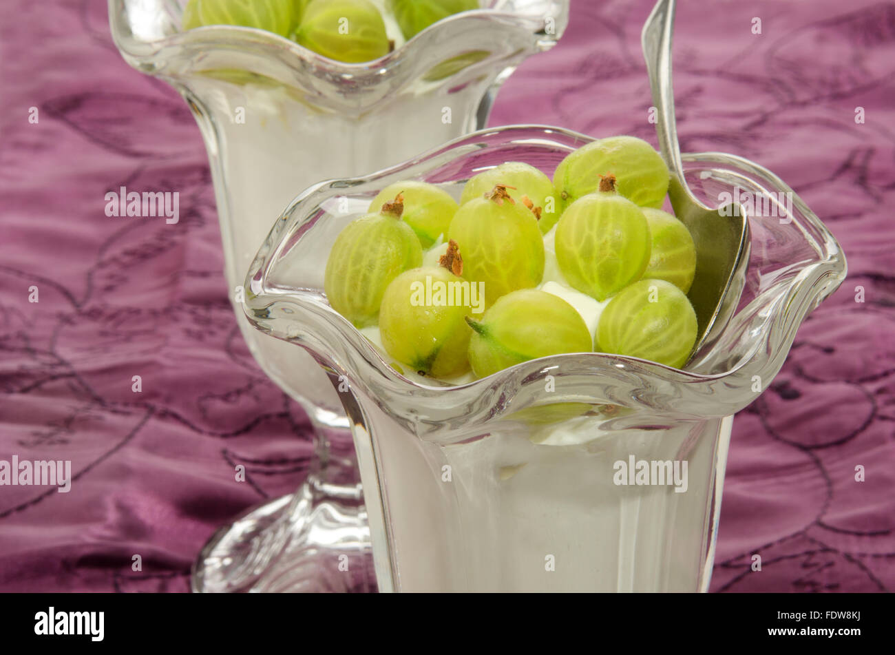 gooseberries with fresh yogurt and spoon in a glass Stock Photo - Alamy