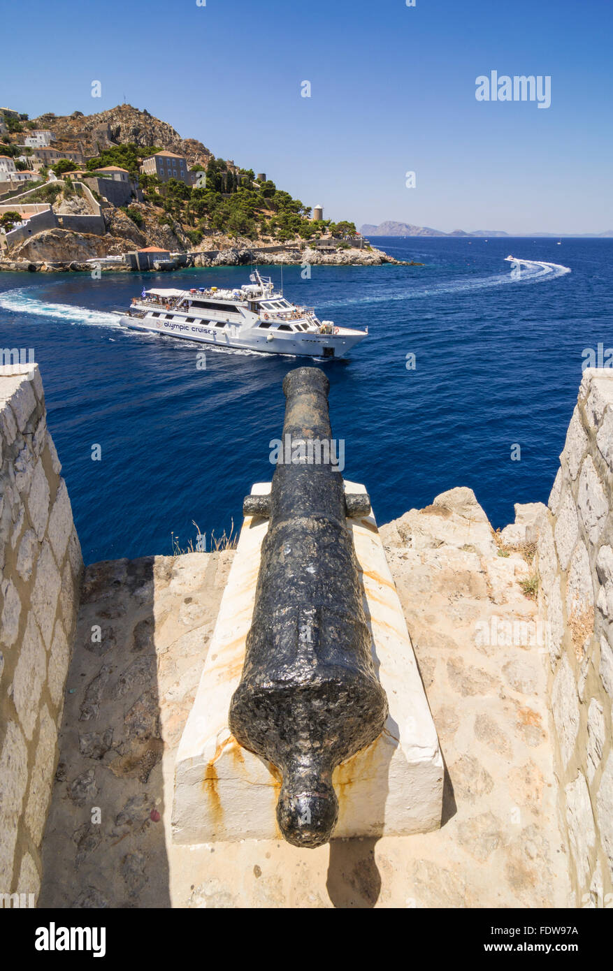 Cannon pointing out to sea on the seafront of Hydra Town, Hydra Island ...