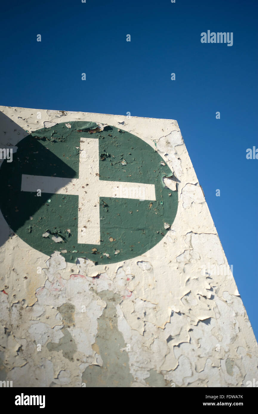Crumbling first aid post sign / painted cross Stock Photo - Alamy