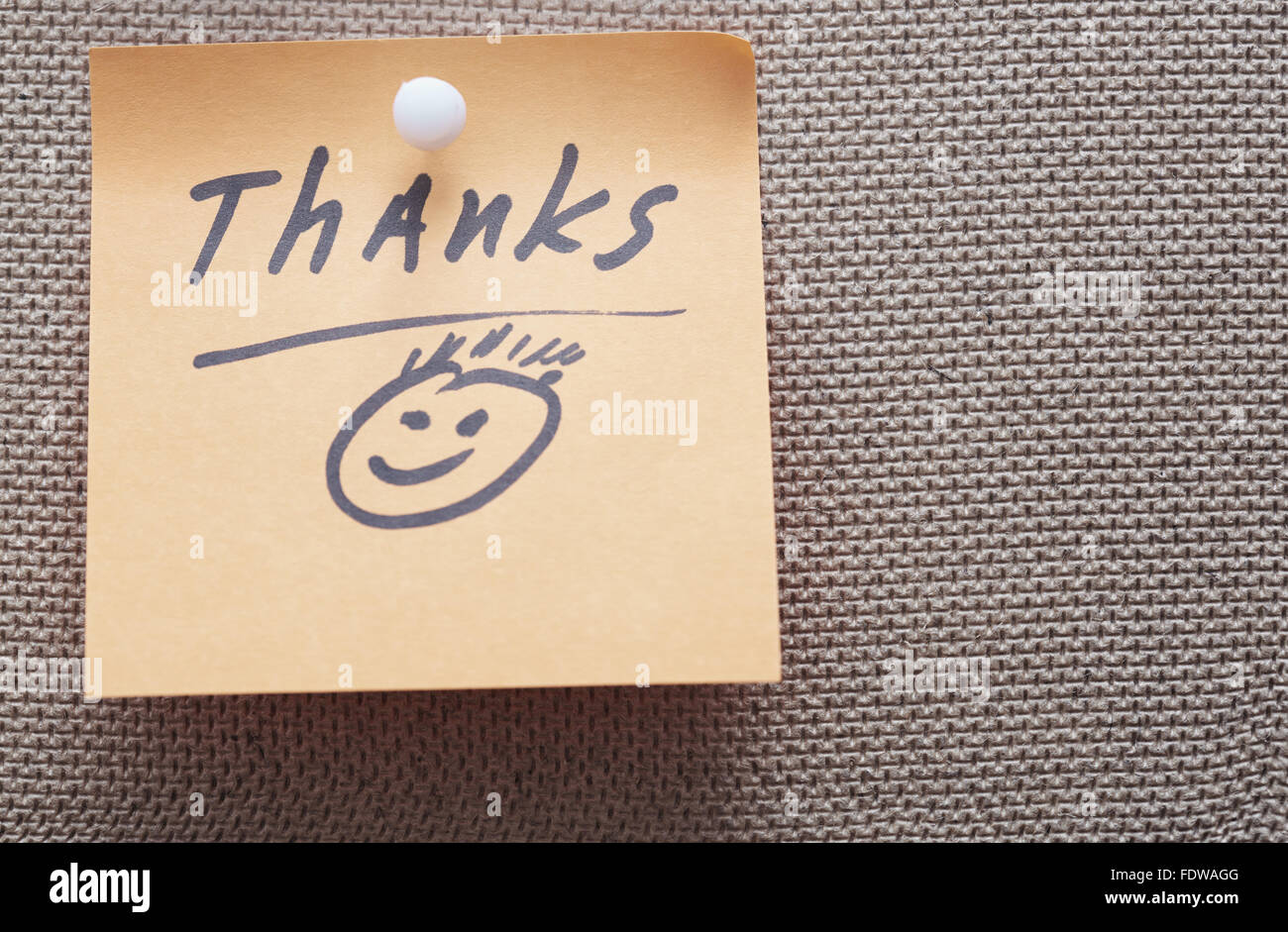 Adhesive note with Thanks text on a bulletin board Stock Photo - Alamy
