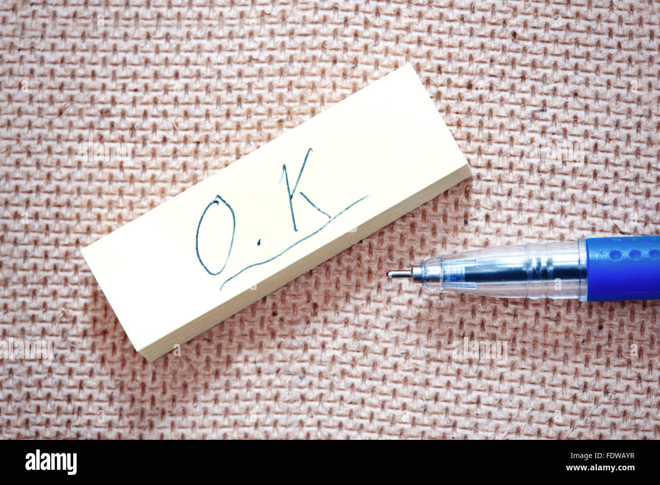 OK sign written on a label and blue pen Stock Photo - Alamy