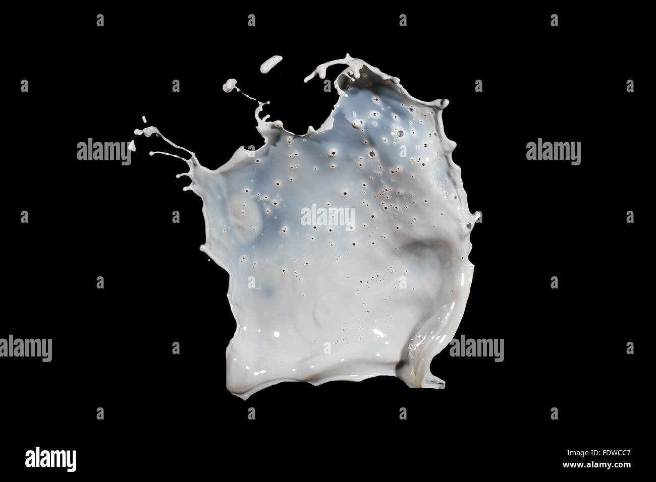 White milk splash isolated on black background Stock Photo - Alamy