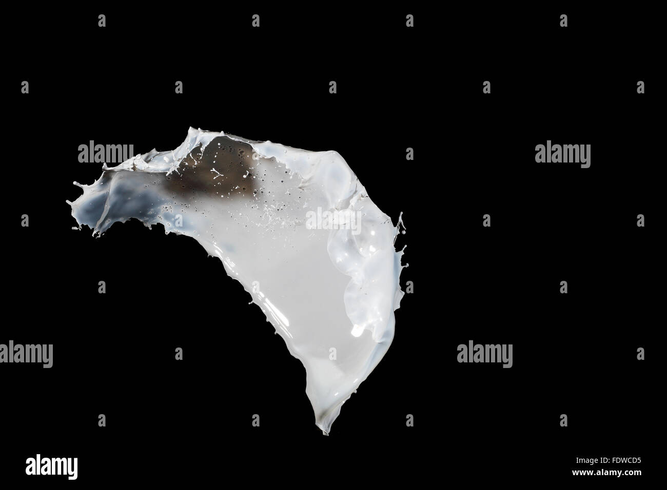 White milk splash isolated on black background Stock Photo - Alamy