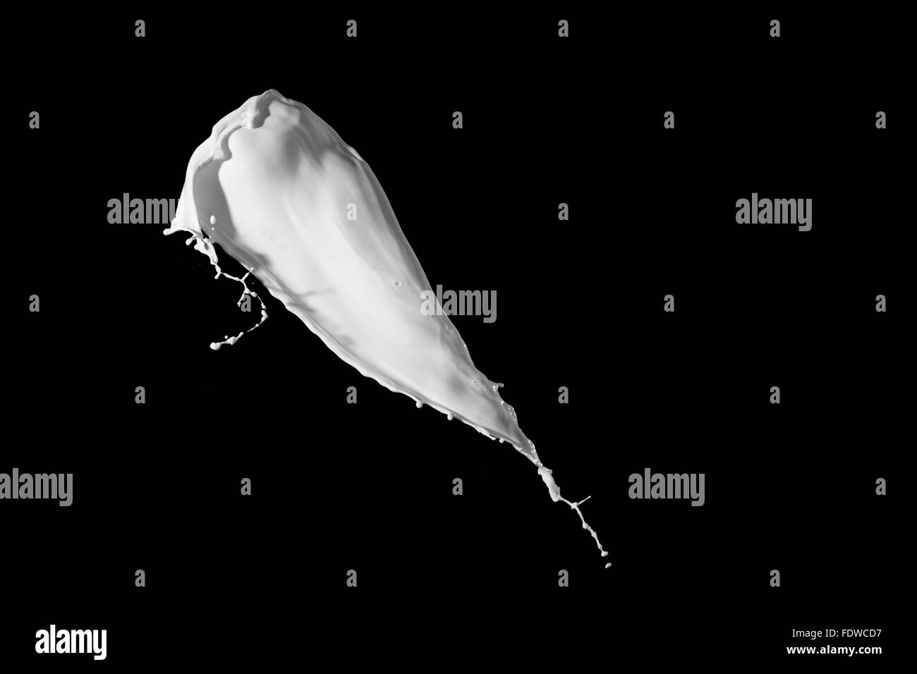 White milk splash isolated on black background Stock Photo - Alamy