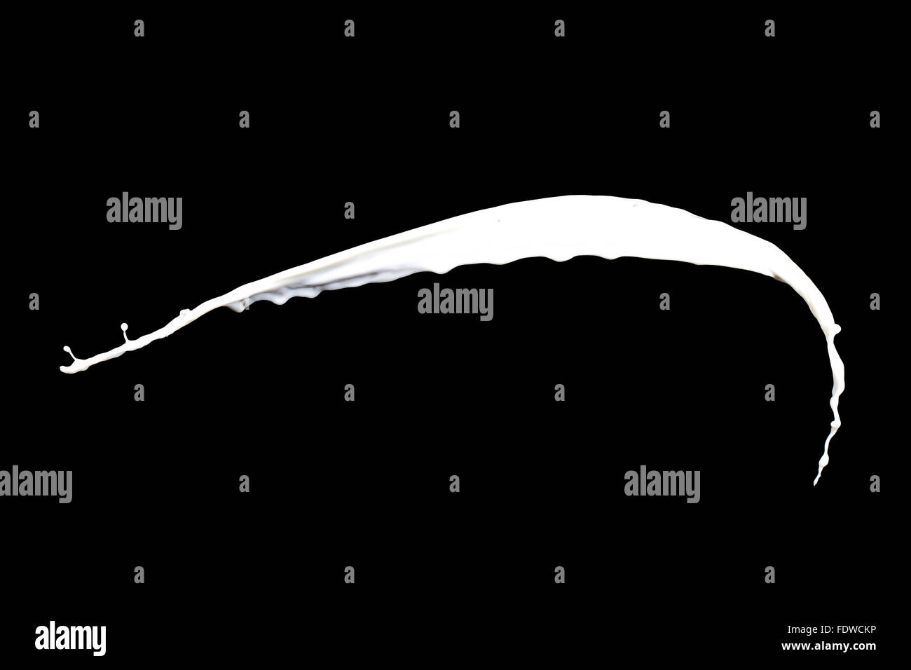 White milk splash isolated on black background Stock Photo - Alamy