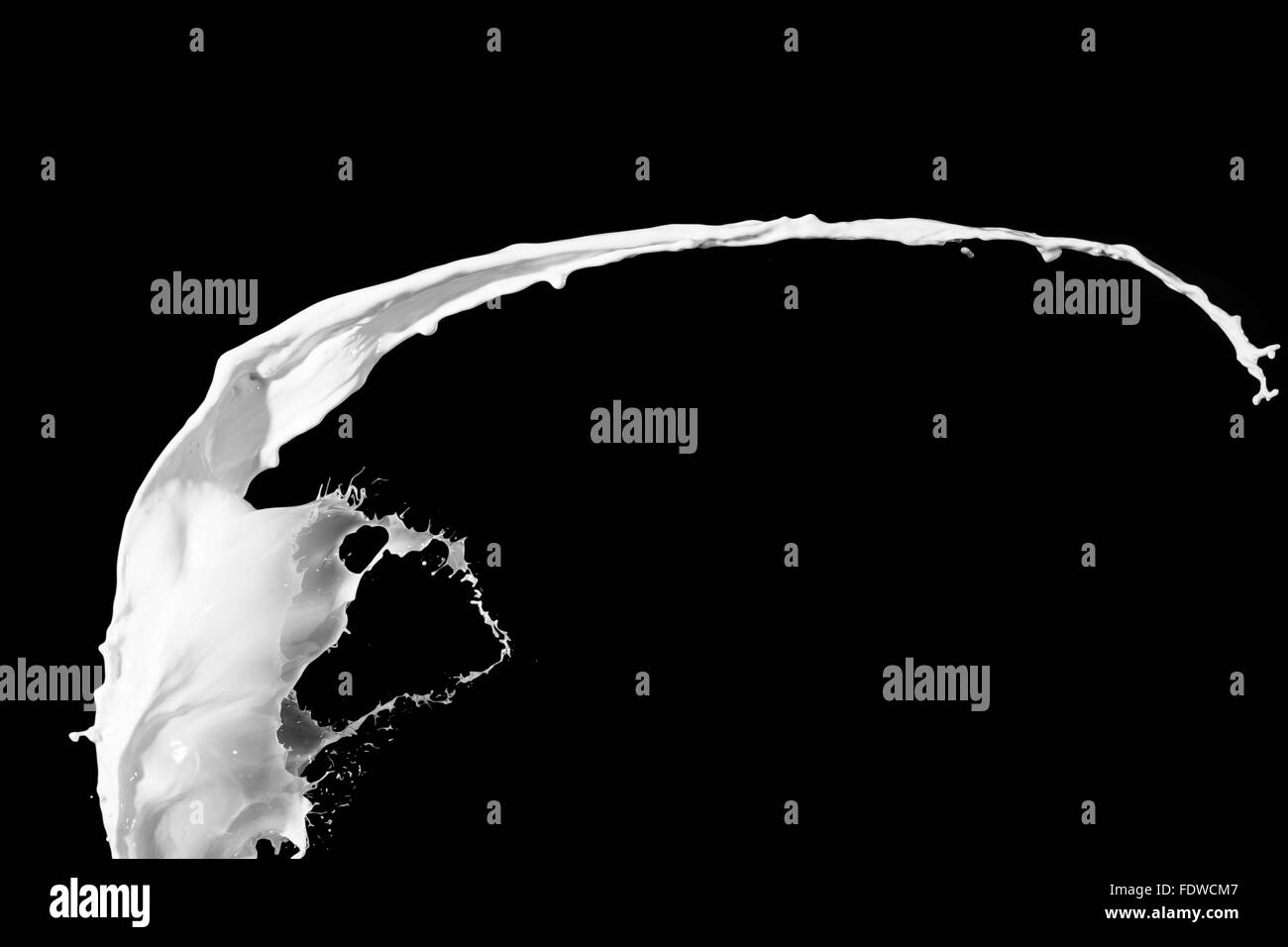 White milk splash isolated on black background Stock Photo - Alamy