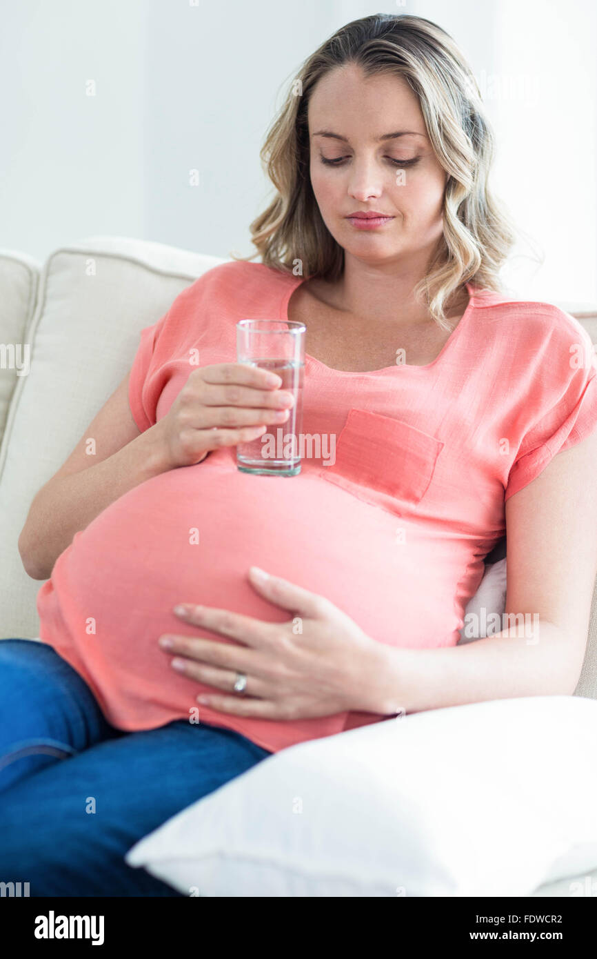 Pregnant woman drinking water Stock Photo - Alamy