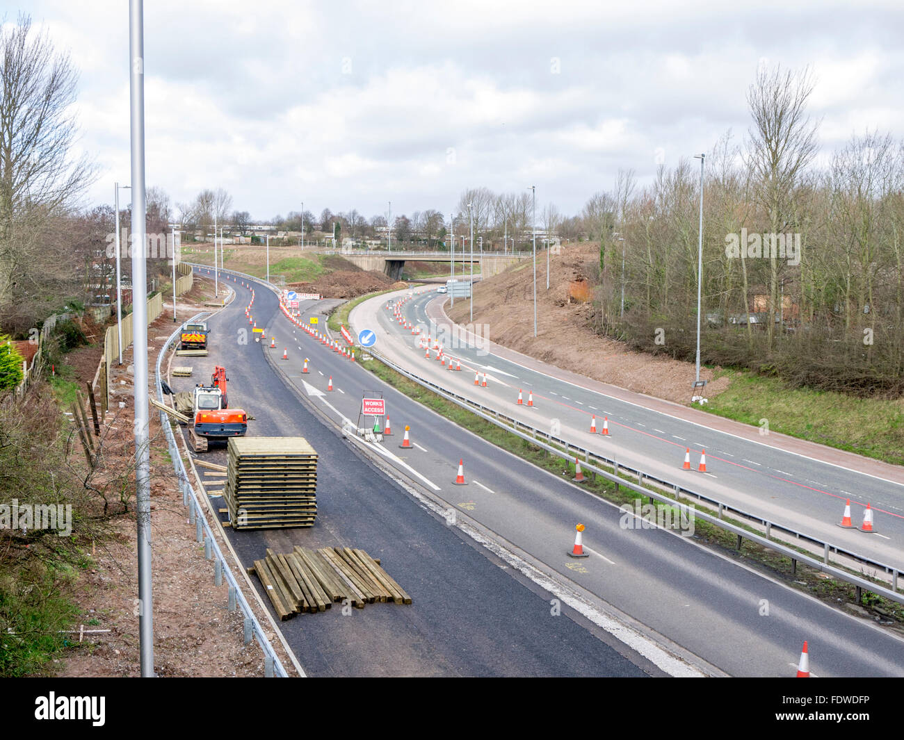 Construction of a new road layout with a digger and coned off area of ...